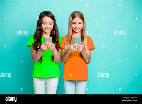 Photo Of Two Girls Browsing Through Their Newly Bought Phones Typing