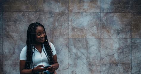 하루 동안 도시에서 스마트폰을 사용하는 쾌활한 아프리카계 미국인 여성 사진 Unsplash의 무선 기술 이미지