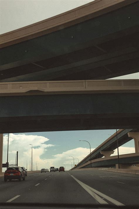 Highway Overpasses Frame The Road With Passing Cars Photo Free Car