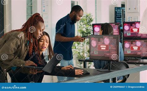 Diverse Group Of Engineers Having Computer Hacked And System Crash On Multiple Monitors Stock