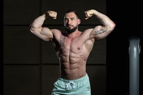 Premium Photo Bodybuilder Performing Rear Double Biceps Pose