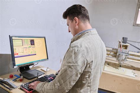 Operator Entering Coordinates On Computer For Cnc Machine To Precisely