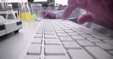 Scientist Laboratory Conducts Research Types Keyboard And Writes Down
