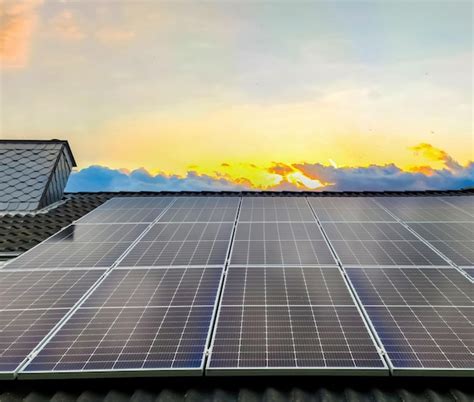 Солнечные панели производящие чистую энергию на крыше жилого дома в солнечную погоду Премиум Фото