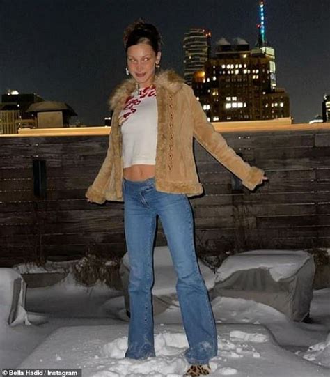 Bella Hadid Flashes Glimpse Of Her Midriff As She Frolics In The Snow