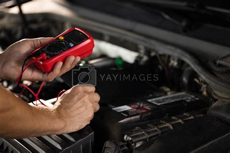 Check Battery Voltage With Electric Multimeter Man Using Multimeter To Measure The Voltage Of