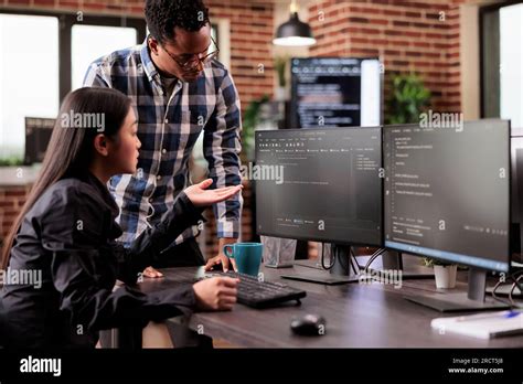 Diverse Team Of System Engineers Developing Html Code And Cloud