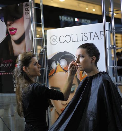 At A Beauty Salon Makeup Artist Applying Eyeshadow On A Young Woman