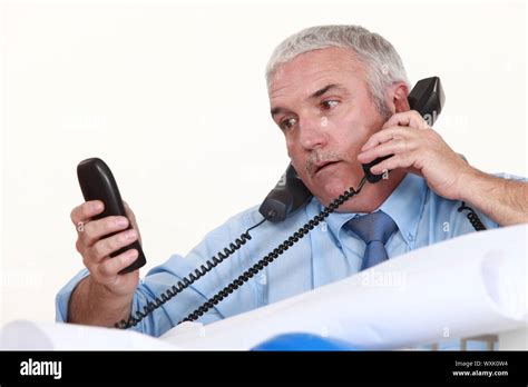 Senior Architect Getting Multiple Calls Stock Photo Alamy