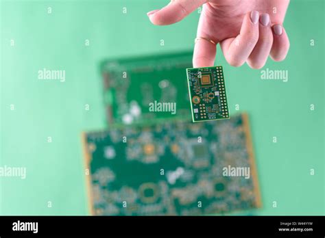 Small Electronics Circuit Boards On Human Woman Finger Female Technician Inspecting Defective