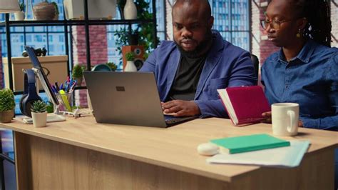 Woman Completing Spreadsheets On Notebook Entering Numerical Data Into Cells Calculating