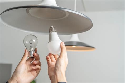 Premium Photo Asian People Replace Fluorescent Light Bulbs CFL With New LED Bulbs Female Hands