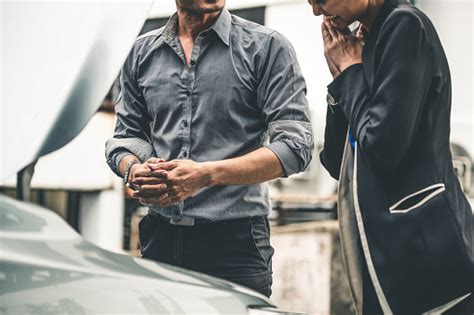 남자는 여자를 도와 자동차 문제를 해결 합니다 그는 손상 된 부분을 수리 하기 위해 자동차 후드를 팝업 손상에 대한 스톡 사진