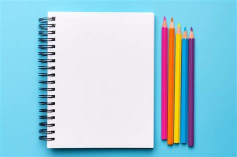 Premium Photo A Notebook And Colored Pencils