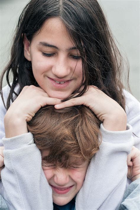 Older Sister Teasing Younger Brother By Stocksy Contributor Kerry