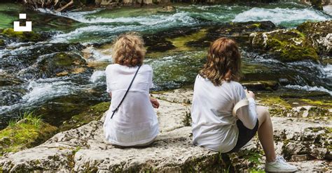 2 Women Sitting On Rock Near River During Daytime Photo Free Vintgar
