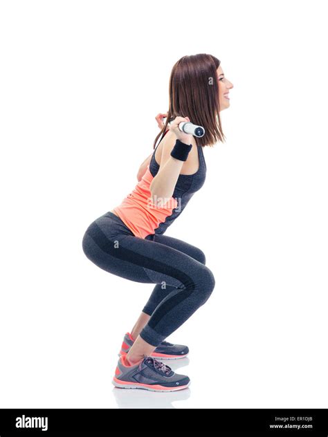 Side View Portrait Of A Fitness Woman Doing Squatting With Barbell