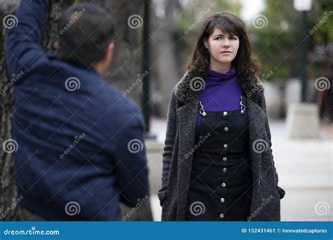 Man Harassing Woman On The Street Or A Criminal Stalking Victim Stock