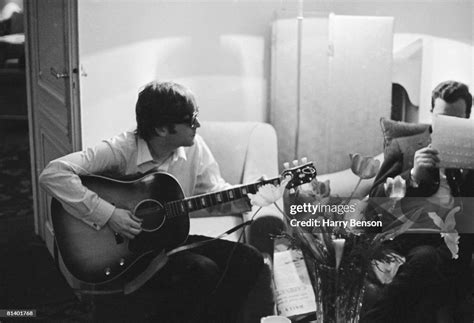 John Lennon Of The Beatles Plays The Guitar In A Hotel Room In Paris