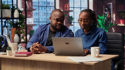 African American Man And Woman At Home Brainstorming Ideas For Their Business Stock Image