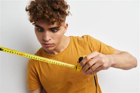 Premium Photo Young Woman Holding Tape Measure Against White Background