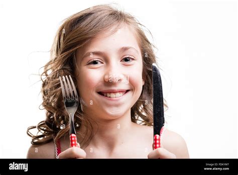 Smiling Girl With Fork And Knife Is Going To Eat Everything She Will Find Stock Photo Alamy