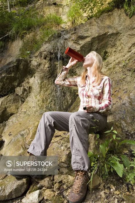 Young Woman Drinking From Thermos Flask Superstock