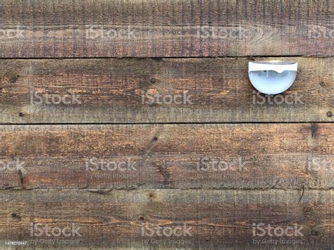 태양 전지판으로 구동되는 Led 전구는 처리되지 않은 나무 판자로 만든 벽에 매달려 있습니다 환경 친화적 인 건물 건설 및 환경 재료 및 재생 가능 자원의 사용 0명에 대한