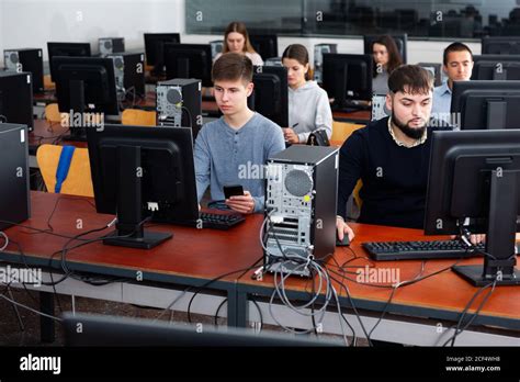 Group Of Positive Concentrated People Of Different Ages Learning To Use Computers In Classroom