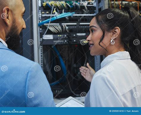 Do We Understand Each Other Two Workers Inspecting The Electronic Equipment In A Server Room