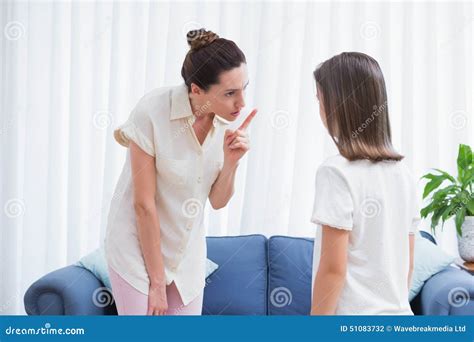 Naughty Daughter Sitting On Sofa With Frowning Eyebrows Royalty Free