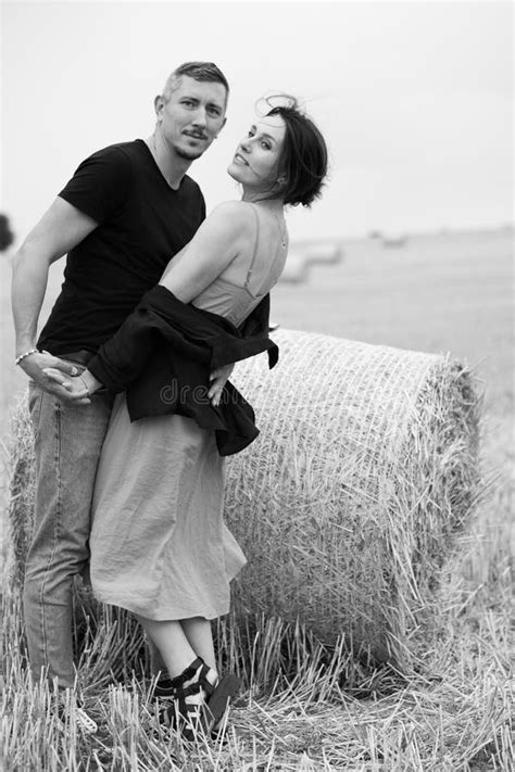 A Young Couple Of Beautiful People Have Fun In The Field Near Round
