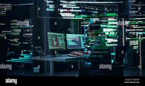 Female Programmer Working In Monitoring Control Room Surrounded By Big Screens Displaying Lines