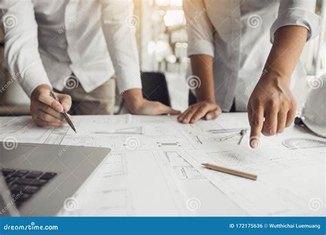 Engineers Are Helping To Design Work On Blueprints And Collaborate On Structural Analyzing Of