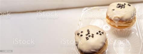 플라스틱 투명한 용기에 흰색 배경에 설탕과 초콜릿 칩을 장식 한 두 개의 맛있는 도넛 왼쪽에있는 공간의 사본이있는 배너 달콤한 롤빵에 대한 스톡 사진 및 기타 이미지