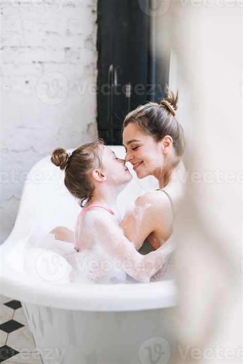 Young Mother Woman And Little Tween Girl Daughter Having Fun In Bath With Foam At Home 16277281