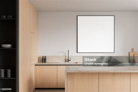 미니멀한 주방 인테리어 천연 목재 캐비닛 레이아웃의 조리대 위 흰색 벽에 빈 사각형 포스터 모형이 있습니다 깔끔한 현대적인 디자인 템플릿 3d 렌더링 3차원 형태에 대한