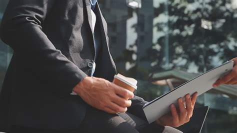 businessman using tablet analyzing sales data and economic growth graph chart business strategy