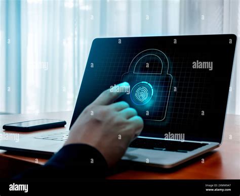Blue Fingerprint Scan And Lock Icon On Laptop Computer Screen While Finger Scanning For Security
