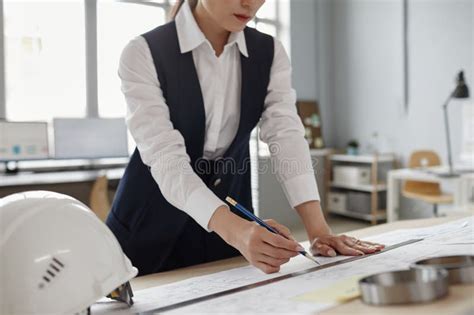 Female Engineer Drawing Blueprints And Plans At Workstation In Office Stock Photo Image Of