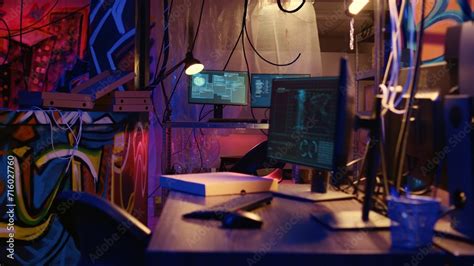 Dolly Out Shot Of Empty Messy Hackers Base Of Operations With Neon Lights And Graffiti Drawings