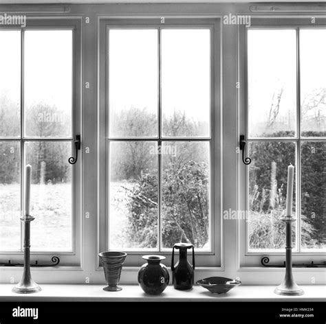 White Window Frame With Window Sill With 2 Candles And Glass Ornaments