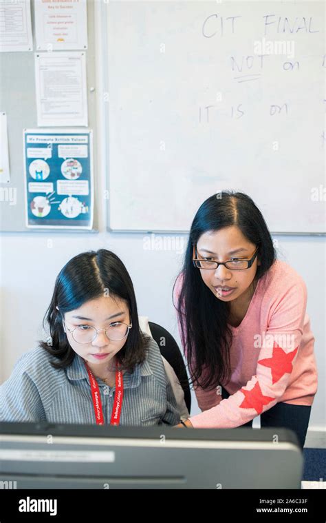 A Computer Technology Class With Students Working And Helping Each A Computer Technology Class With Students Working And Helping Each
