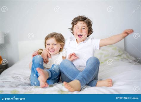 Brother And Sister Relaxing Together In Bed Stock Image Image Of