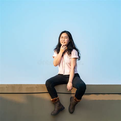Glasses Asian Woman Is Sitting On The Rooftop Barricade Cement Not Dangerous Because The