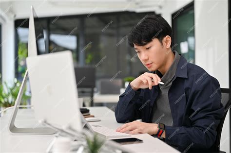 Premium Photo Asian Male Programmer Working At His Office Desk Young