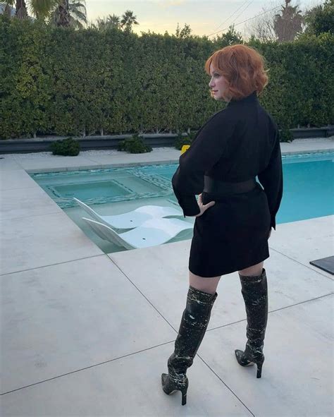 Christina Hendricks Poses Poolside In Sultry Thigh High Boots And Fans