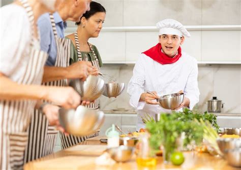 Cooking Course Senior Male Chef In Cook Uniform Teaches Young People