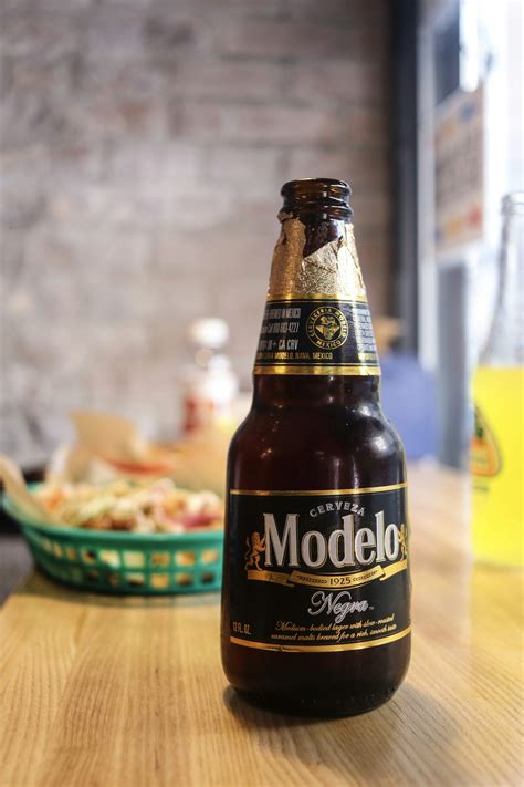 A Bottle Of Modelo Beer Sitting On A Table Photo Free Alcohol Image On Unsplash