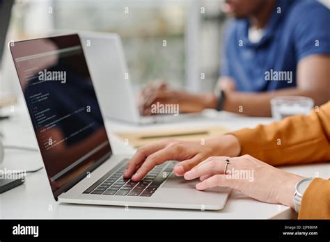 Close Up Of Female Programmer Typing Codes On Laptop During Her Work